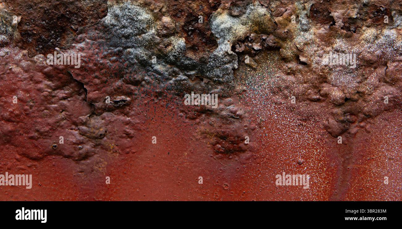 Abstract close-up of rust and aged paint on a corroded metal surface ...