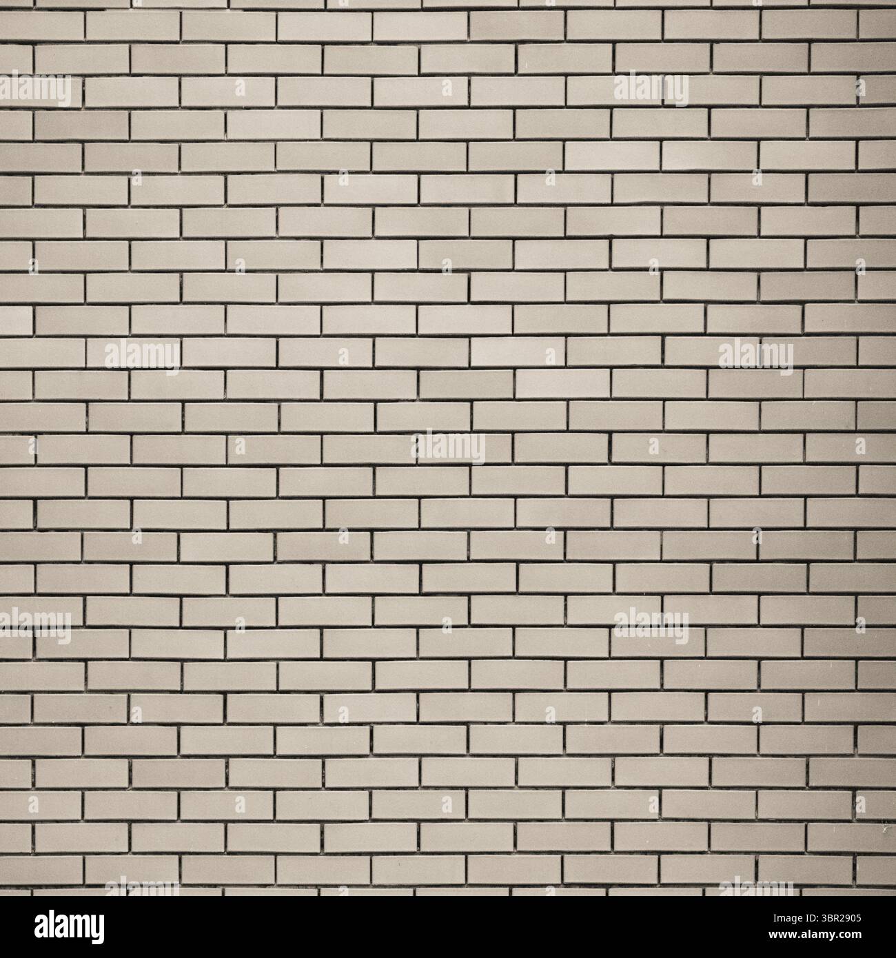 Flat beige brick wall with uniform layout, serving as a neutral ...