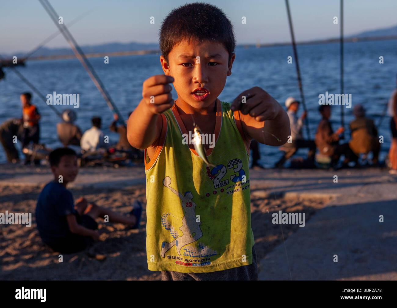 North Korean child boy showing fish he catched, Kangwon Province ...