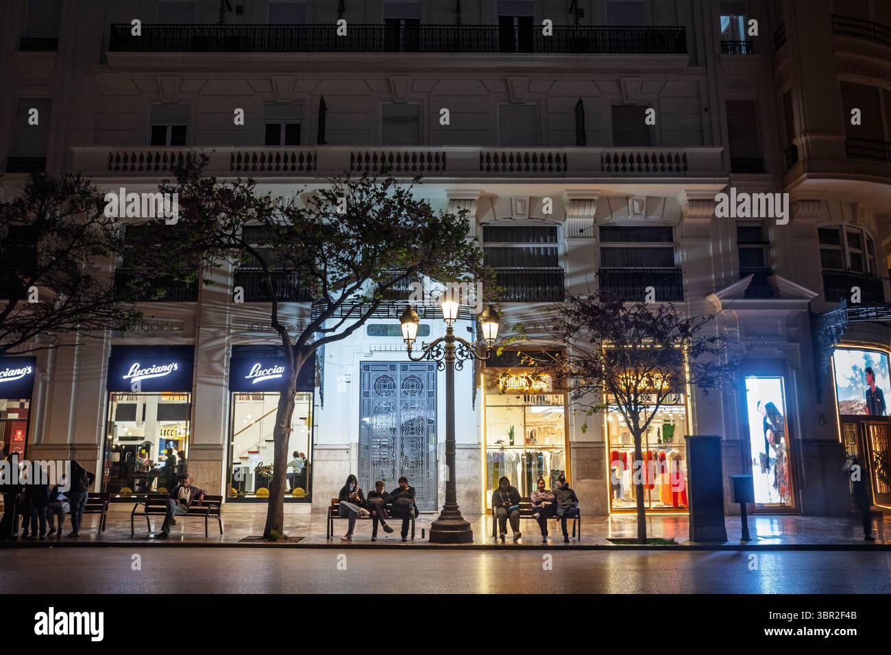 VALENCIA, SPAIN - APRIL 15, 2025: Evening scene on a Valencia boulevard ...