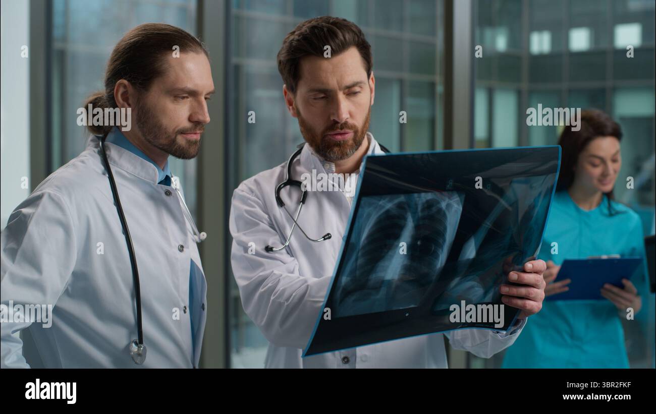 Thoughtful confused two Caucasian men males doctors radiologist and ...