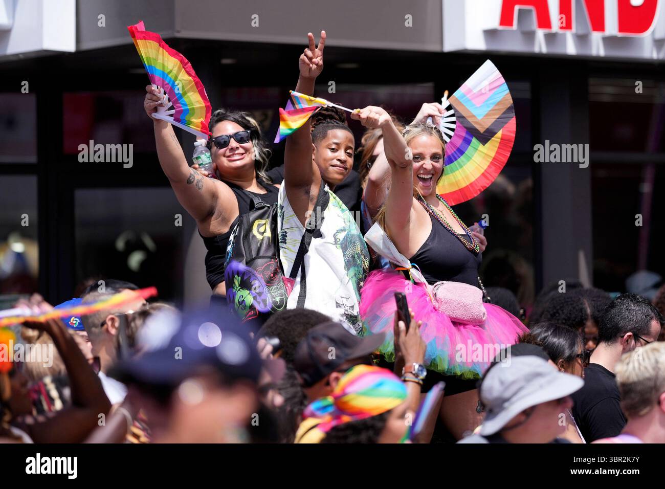 Spectators cheer on parade-goers during the NYC Pride March on Sunday ...
