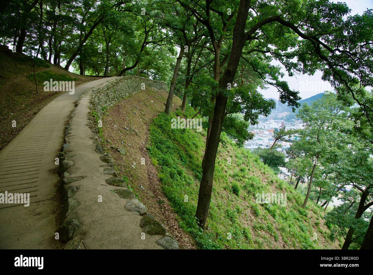 Gongju, South Korea - June 13th 2025: A narrow fortress path curves ...