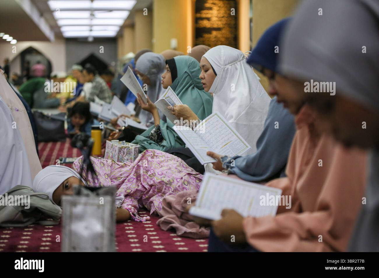 People recite Islamic prayer after performing Maghrib prayers at Masjid ...