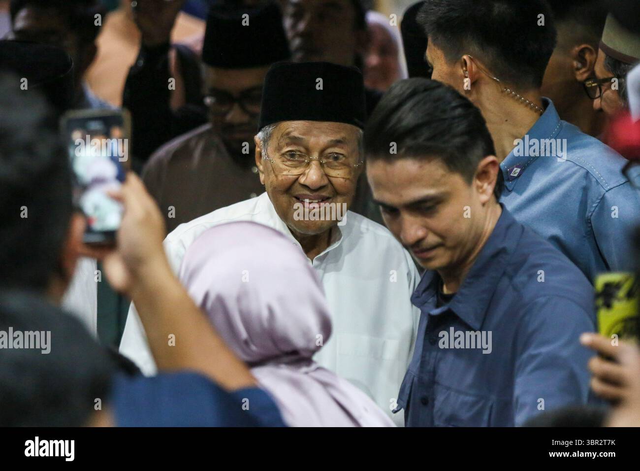 Supporters crowd around Tun Mahathir Mohamad, hoping to greet and shake ...