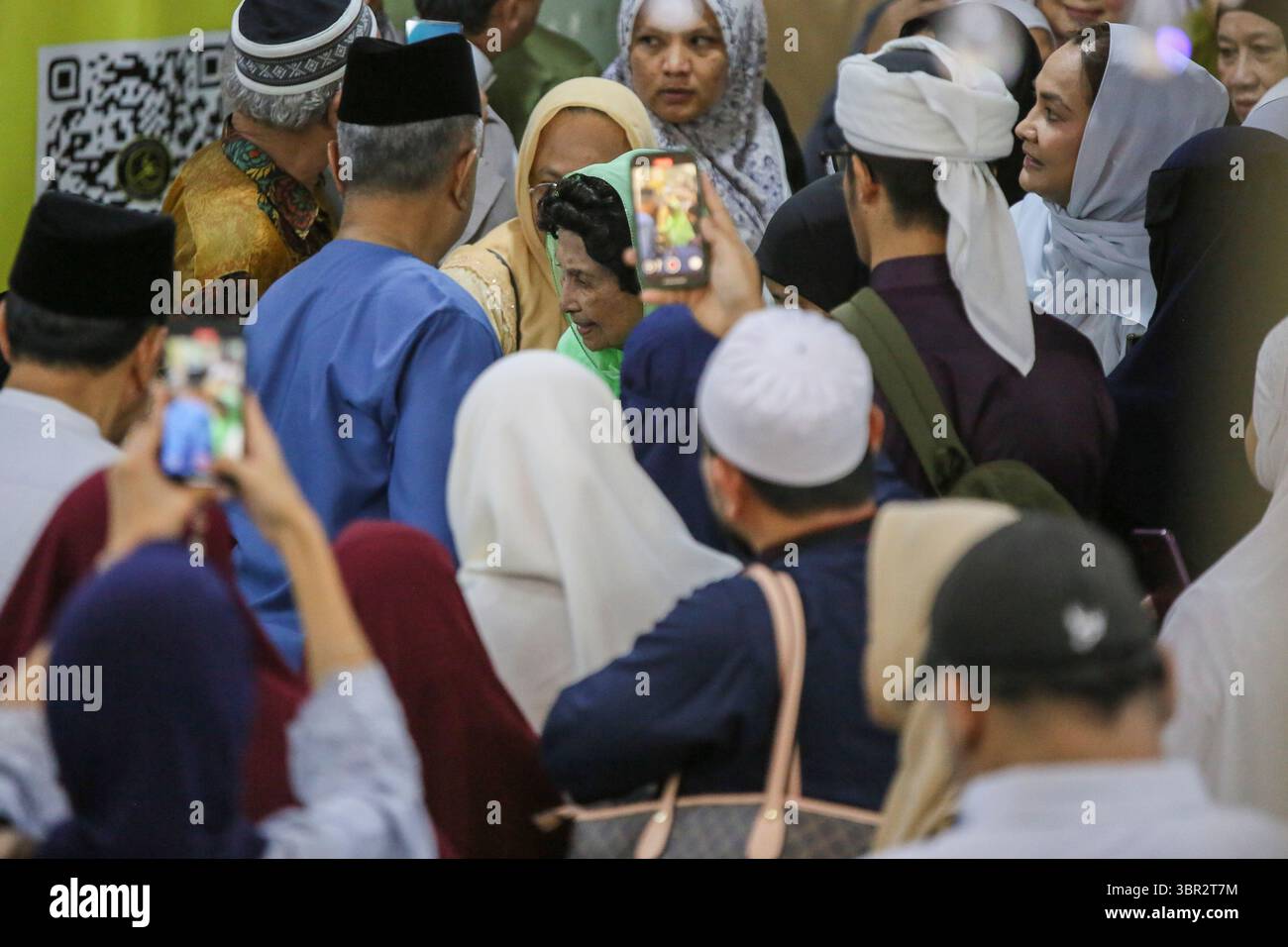 Supporters crowd around Tun Siti Hasmah hoping to greet and shake hands ...