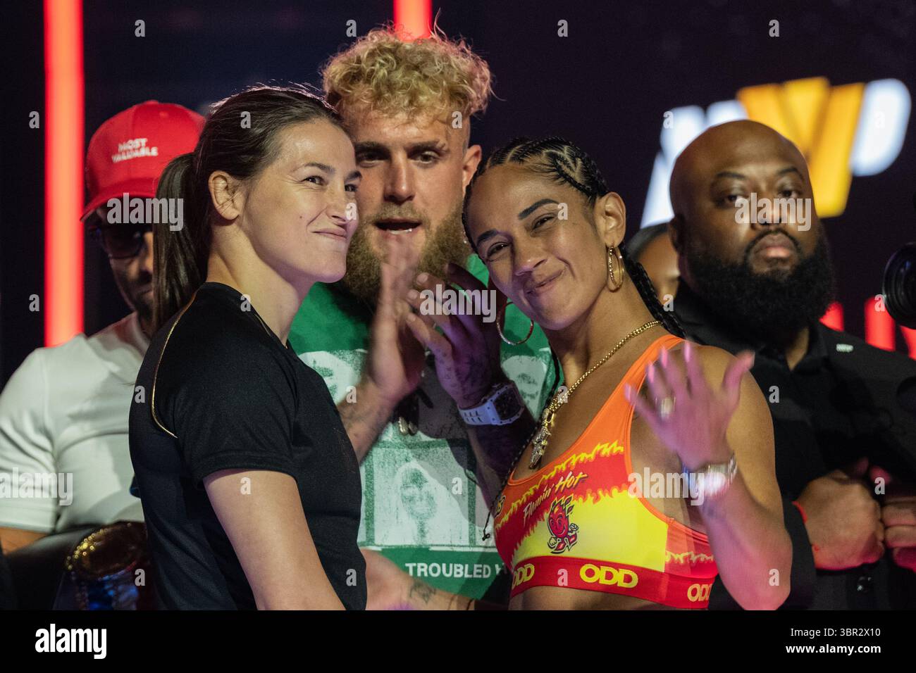 Katie Taylor and Amanda Serrano face off as Jake Paul stands with them ...