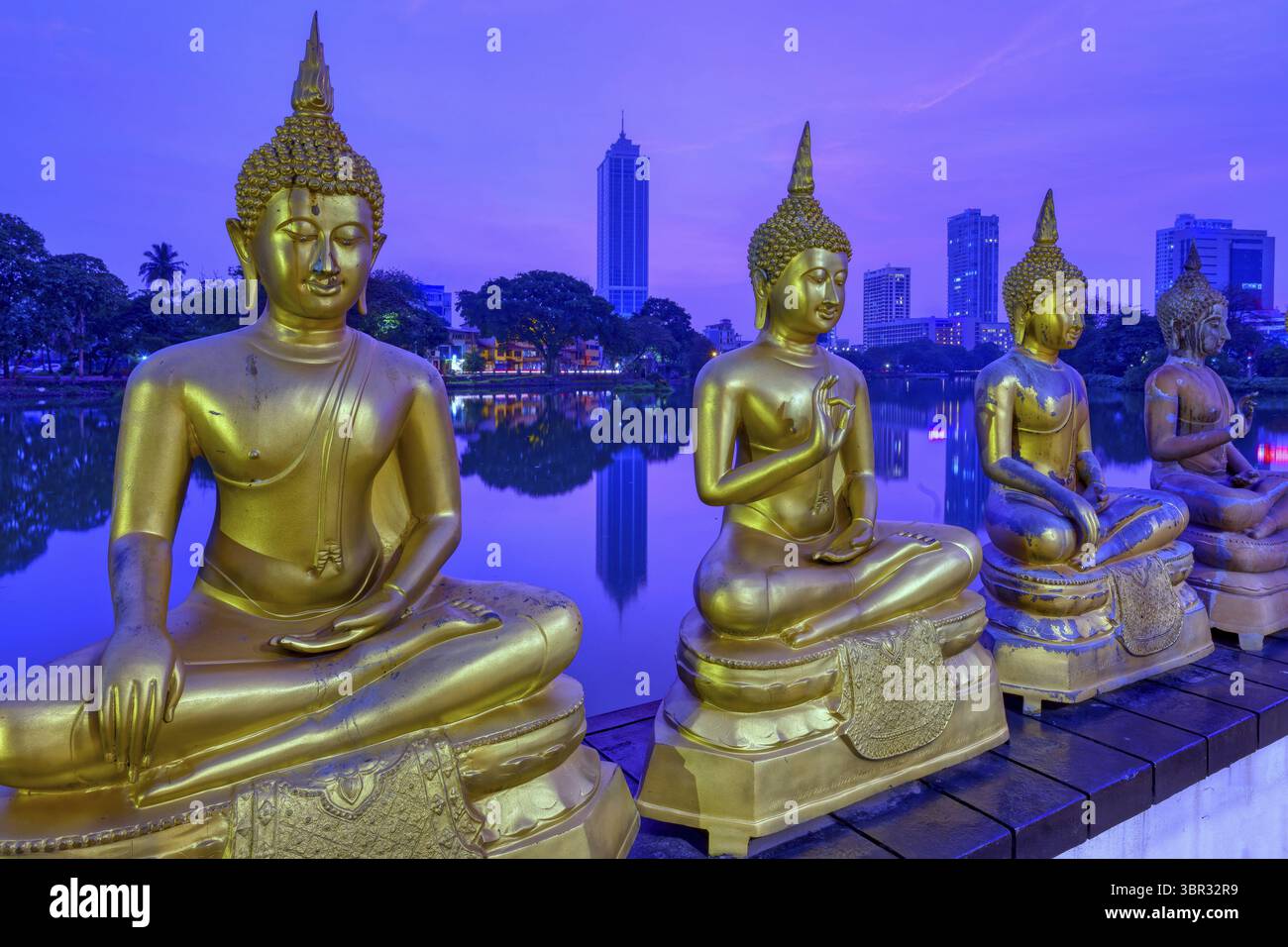 Buddha statues of Seema Malaka Temple at Beira Lake at sunset, Colombo ...