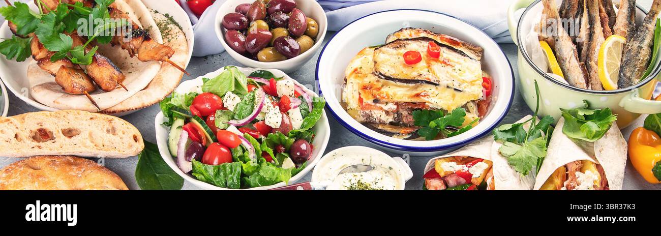 Greek food on grey background. Moussaka, gyros,souvlaki, pita, salad ...
