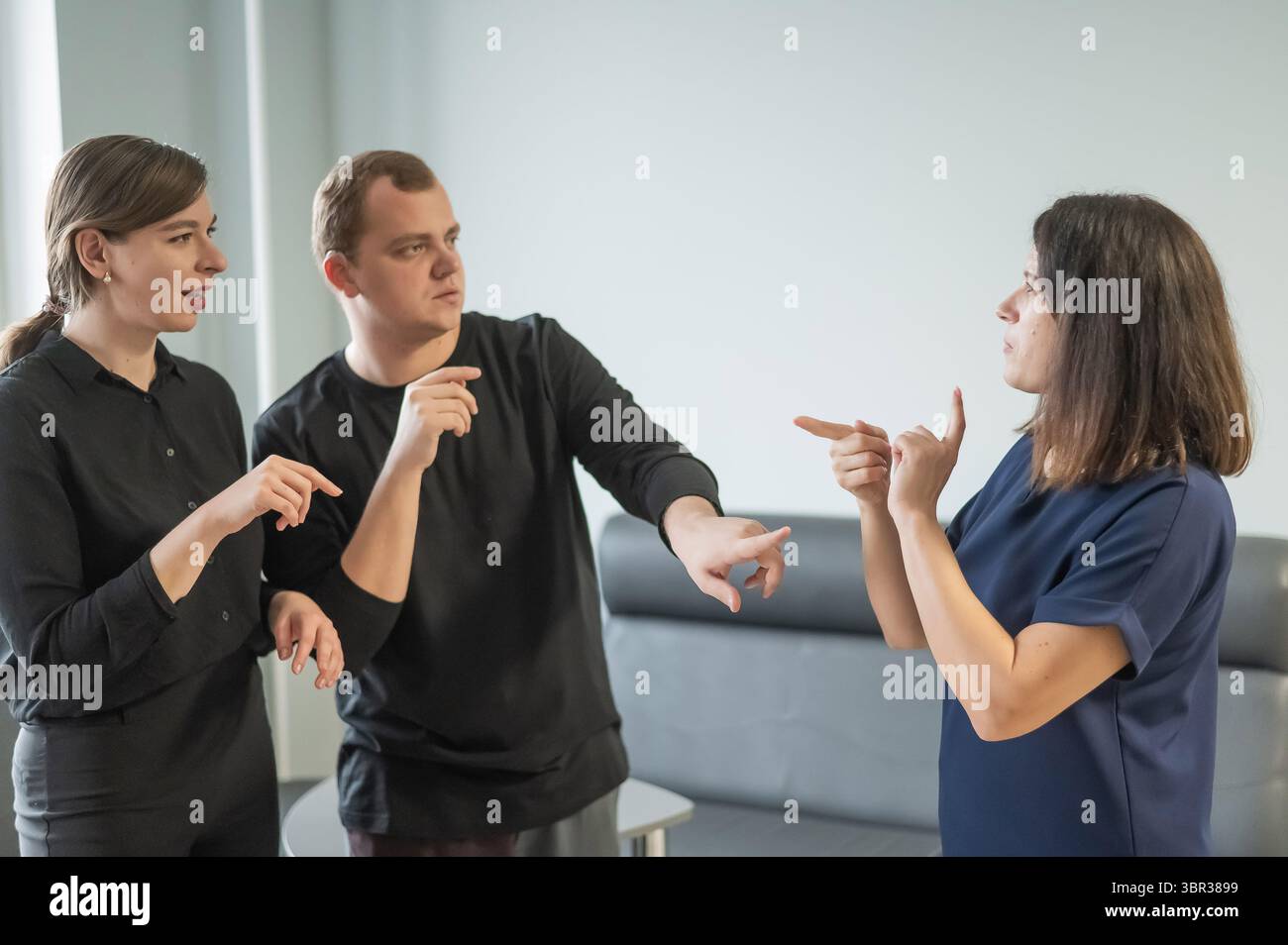 A man and two women are talking in Russian sign language Stock Photo ...