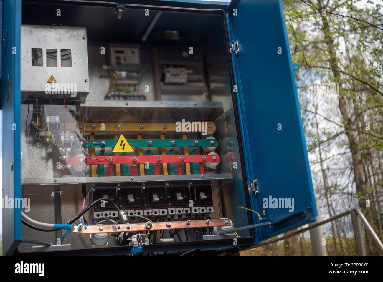 open fuse box with lot of switches and wires, outdoor shot without ...