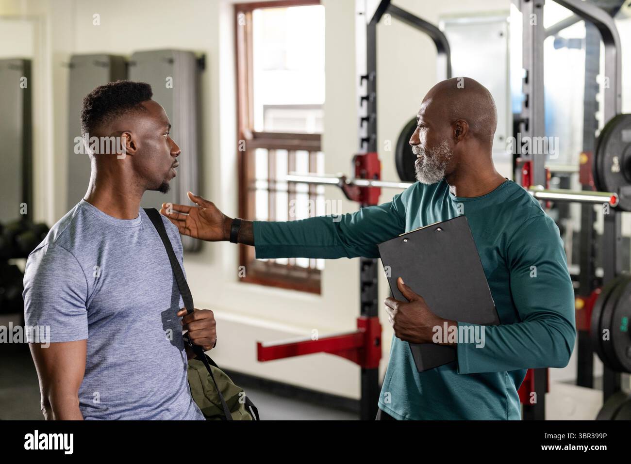 Gesturing trainer client discussing hi-res stock photography and images ...