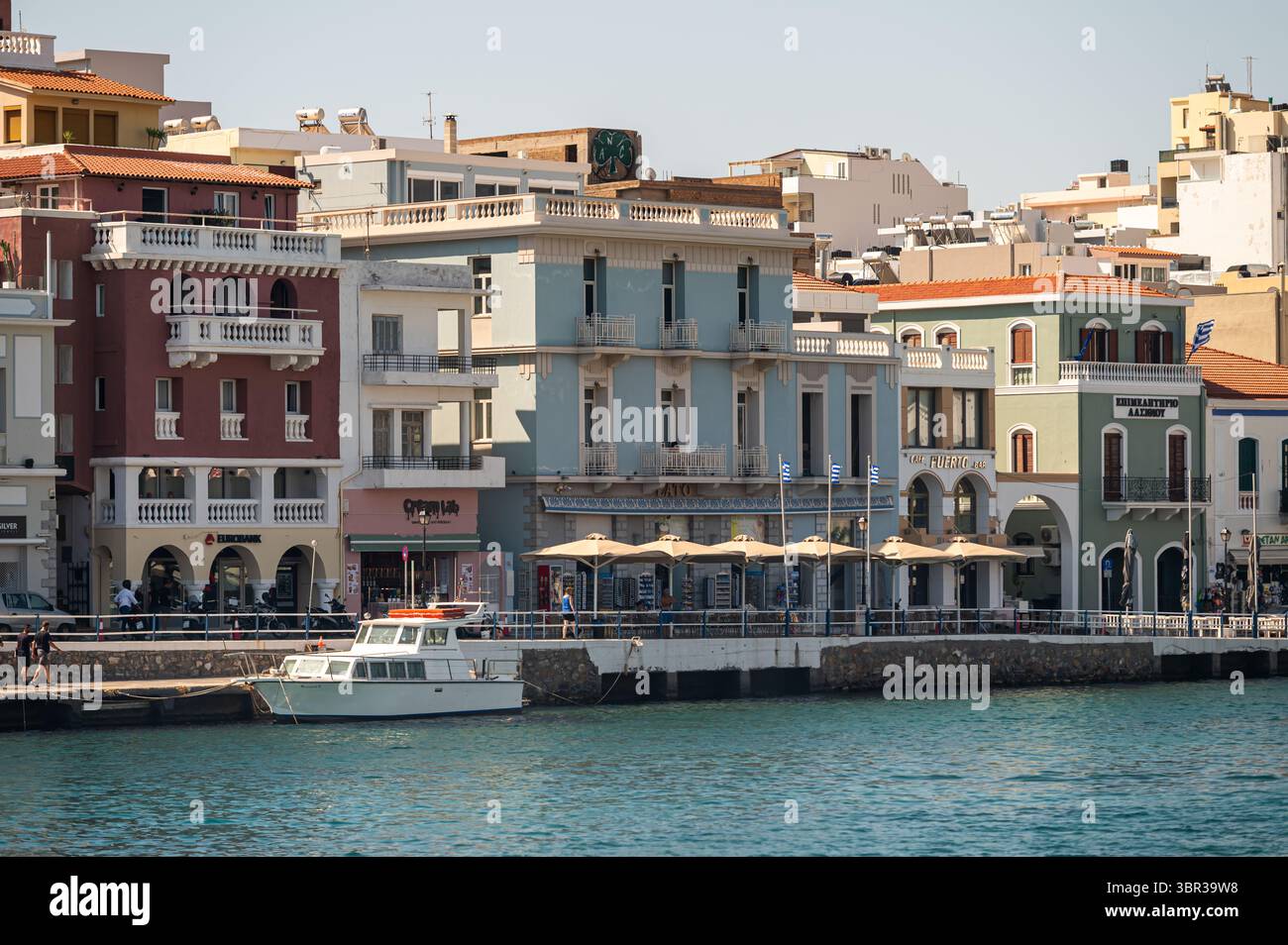 Agios Nikolaos, Crete, Greece - June 26, 2025: Colorful buildings along ...