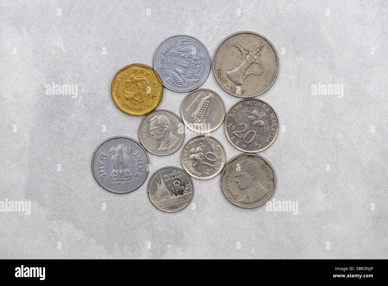 Diverse old coins from various countries, including India, Thailand ...