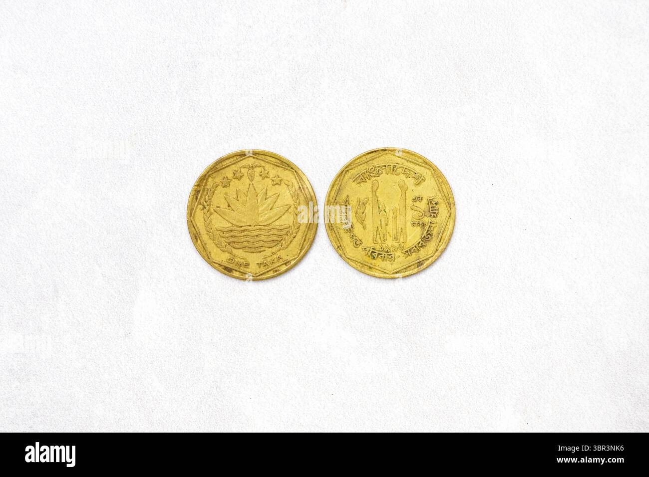 Two old Bangladeshi one Taka brass coins, 1996 issue, showing front and ...