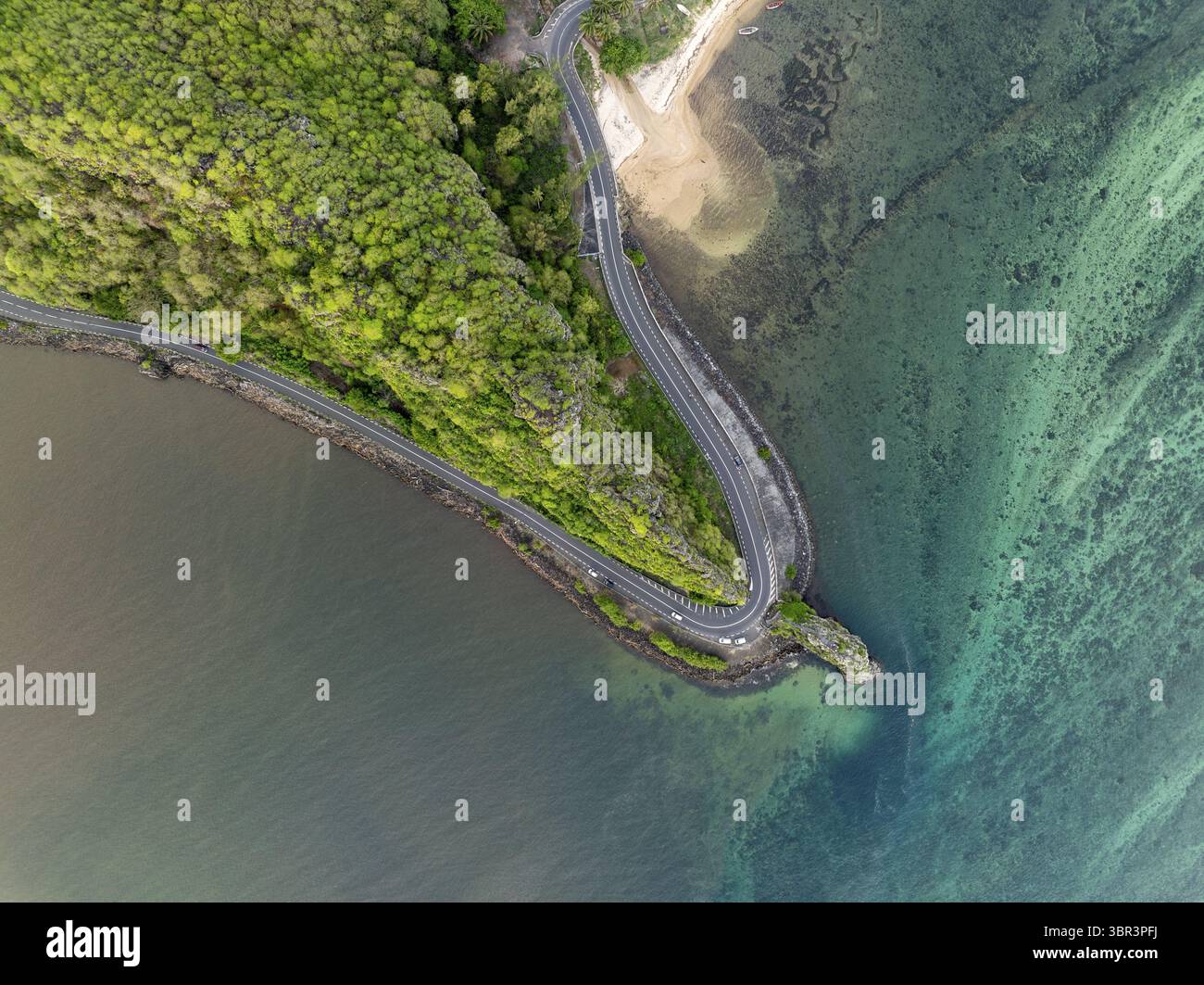 Aerial view of the rugged coastline where lush green cliffs meet the ...