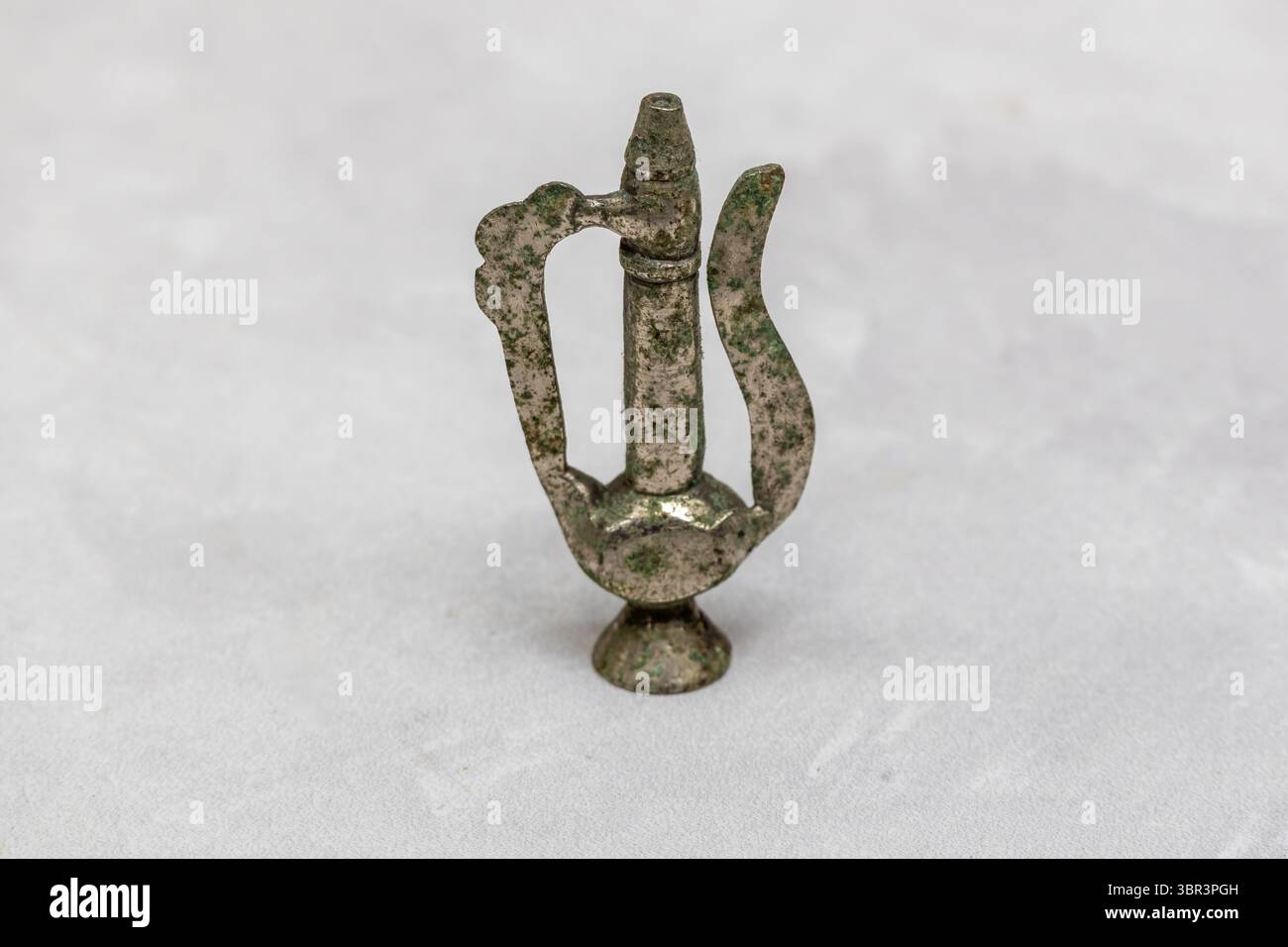 Aged, corroded stainless steel object, similar to the Hindu Trishula ...