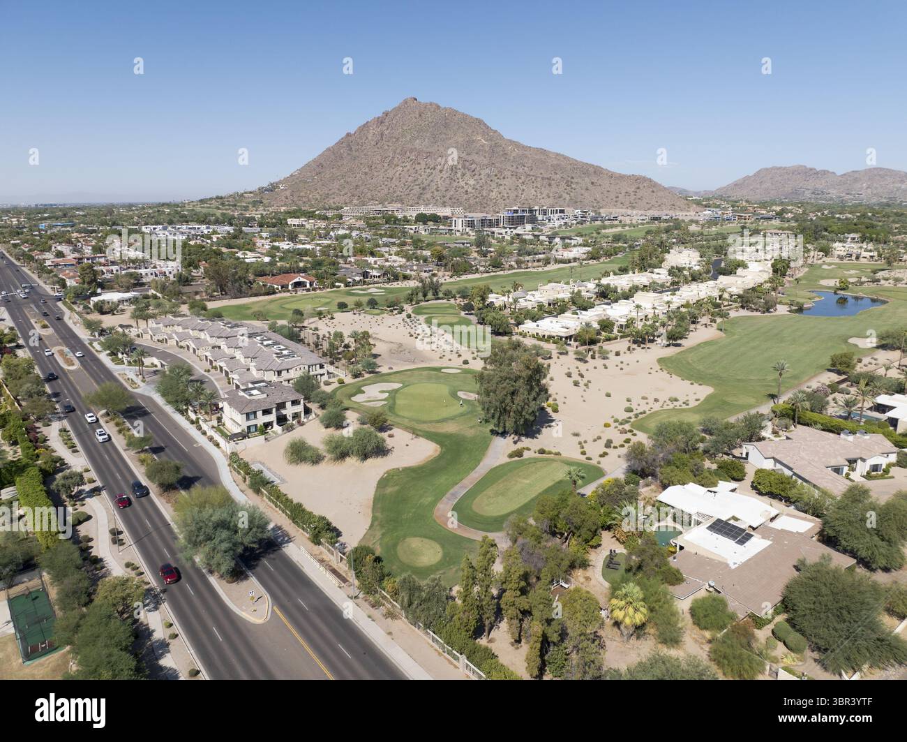 Aerial view of a golf course meanders through the landscape under the ...