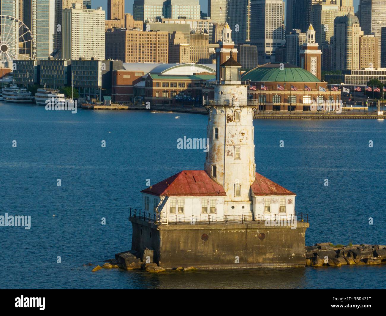 Aerial view of the stark white lighthouse with its red roof stands in ...