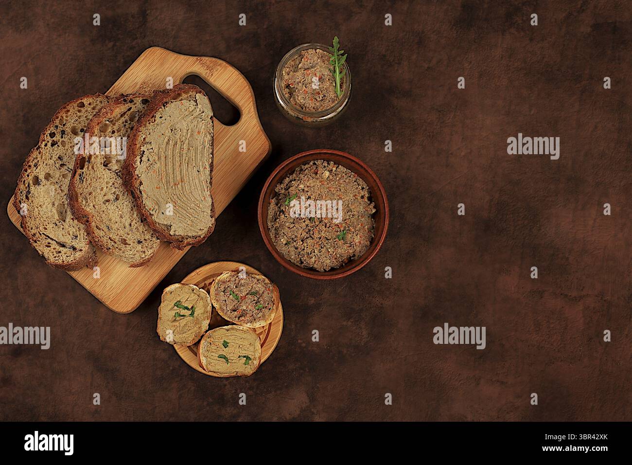 Homemade whole grain bread with chicken pate and arugula on a concrete ...