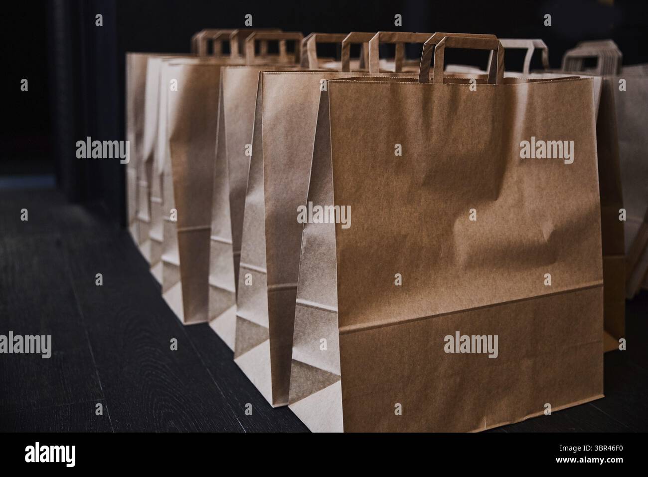 Kraft paper bags stand in a row Stock Photo - Alamy