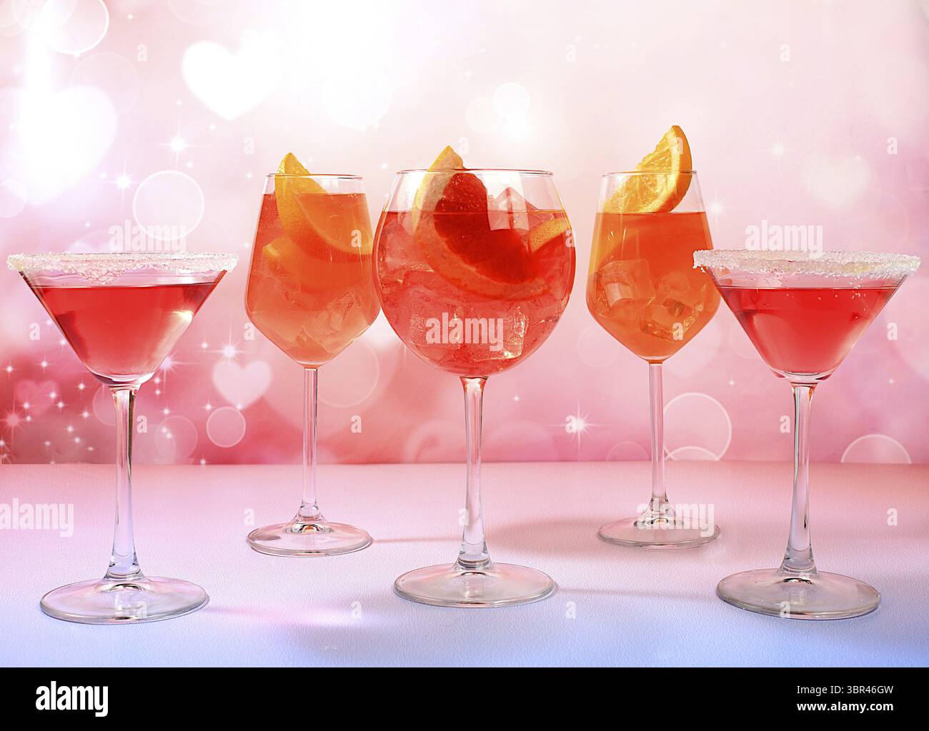 Festive alcoholic cocktail Aperol spritz and red martini in glasses on ...