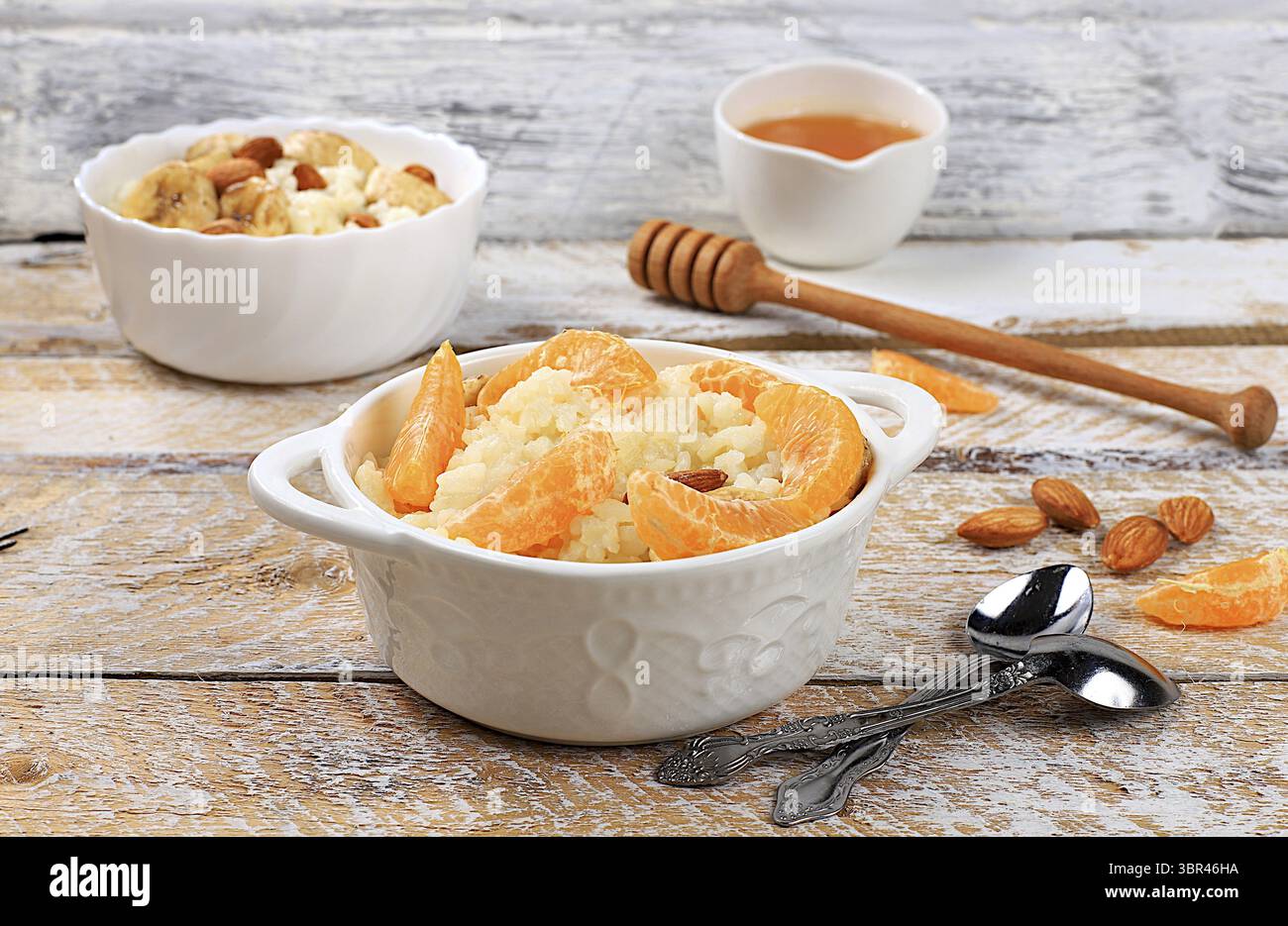 Rice pudding with bananas, honey, tangerines and almonds. Healthy ...