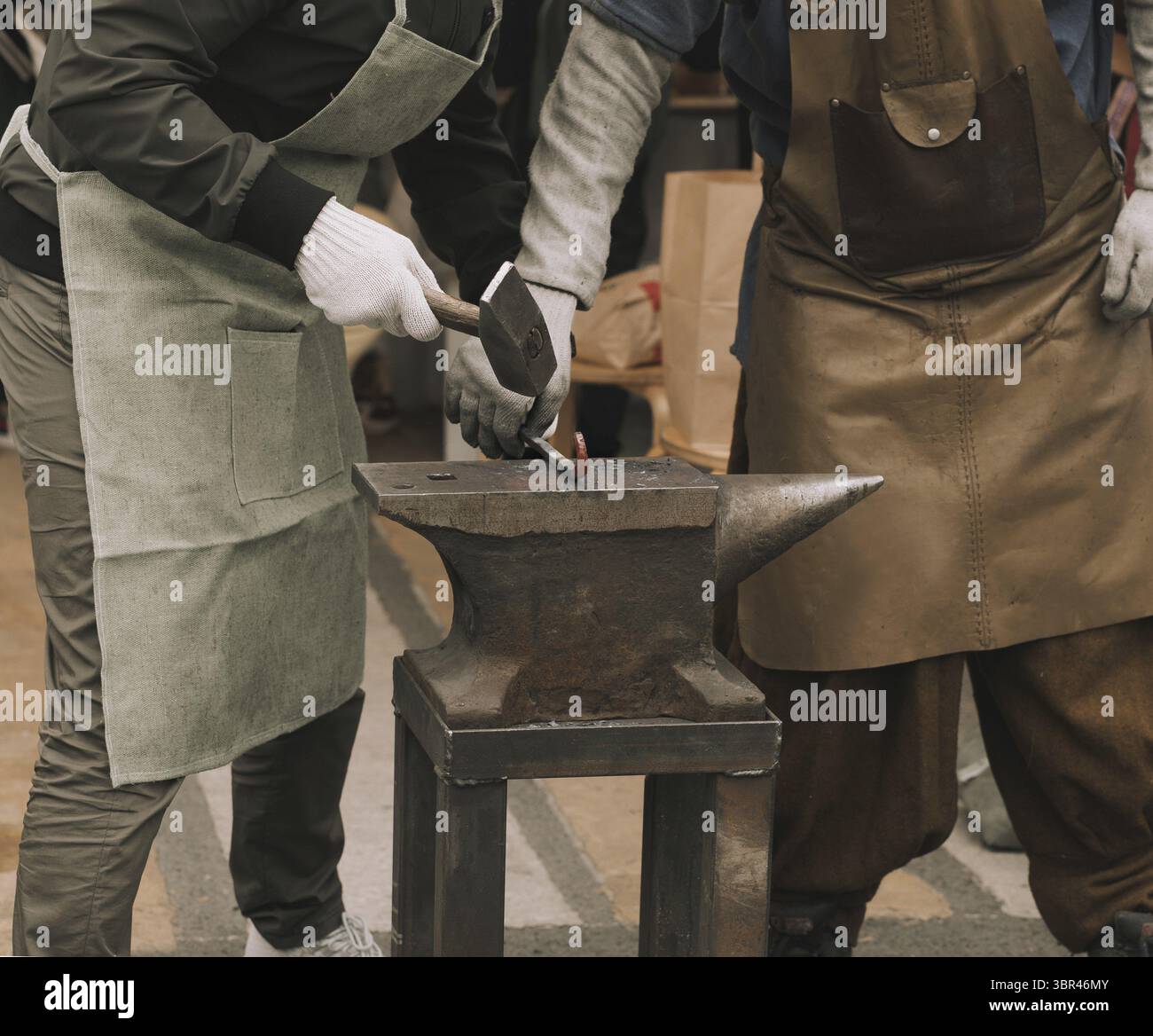 The blacksmith forging the metal on the anvil in smithy Stock Photo - Alamy