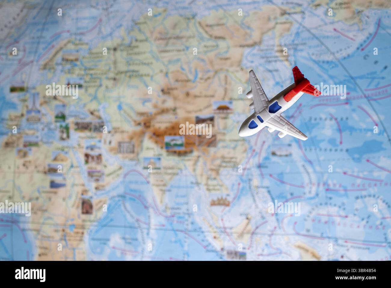 Toy passenger plane flies over the map of Eurasia Stock Photo - Alamy