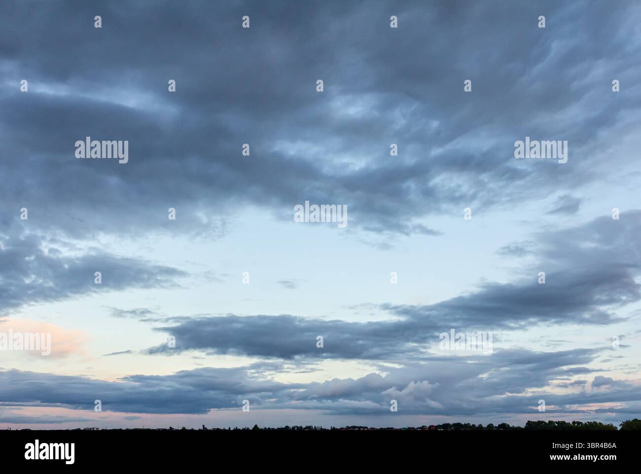 Vast sky filled with dynamic cloud formations during sunset showcasing ...