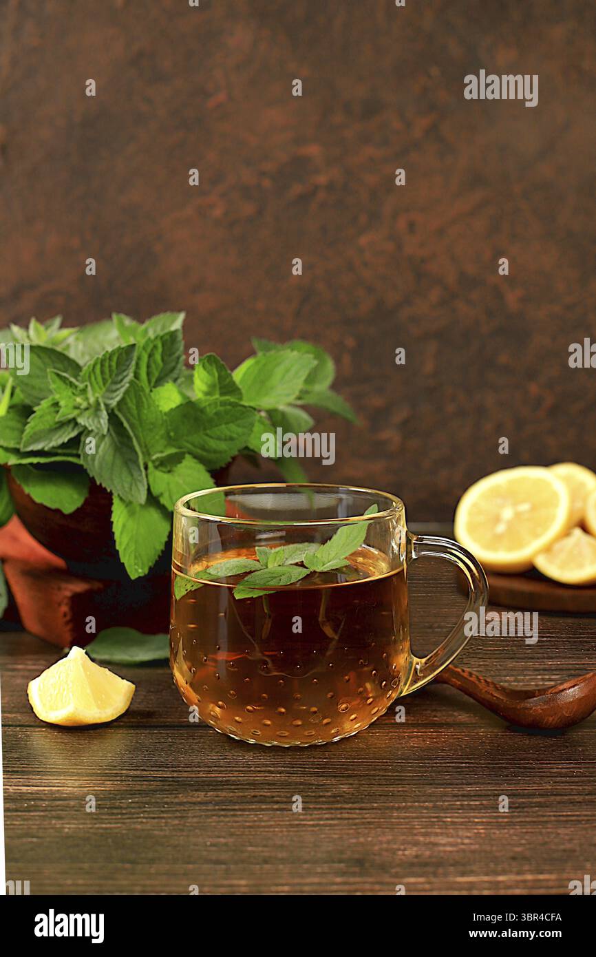 Medicinal herbal tea or infusion of peppermint with lemon with flowers ...