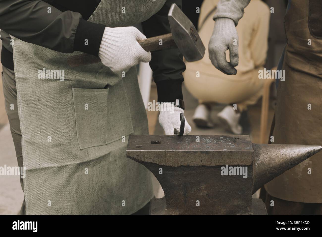 The blacksmith forging the metal on the anvil in smithy Stock Photo - Alamy