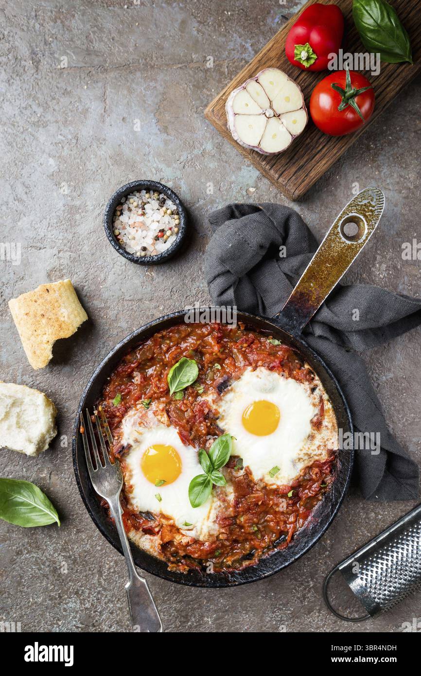 Shakshuka, Fried Eggs in Tomato Sauce in iron frying pan. Typical ...
