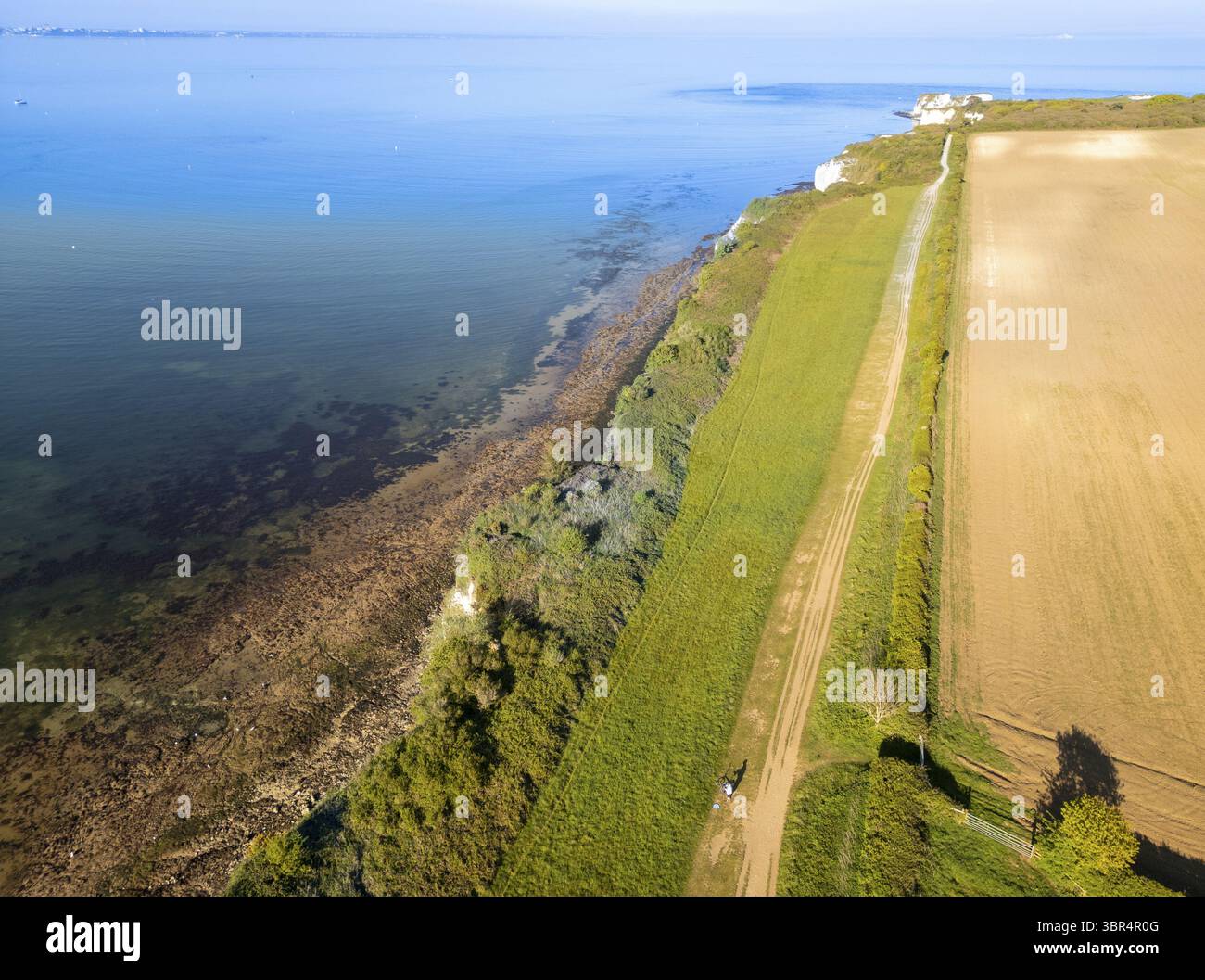 Aerial view of the coast where the turquoise sea meets the rugged ...