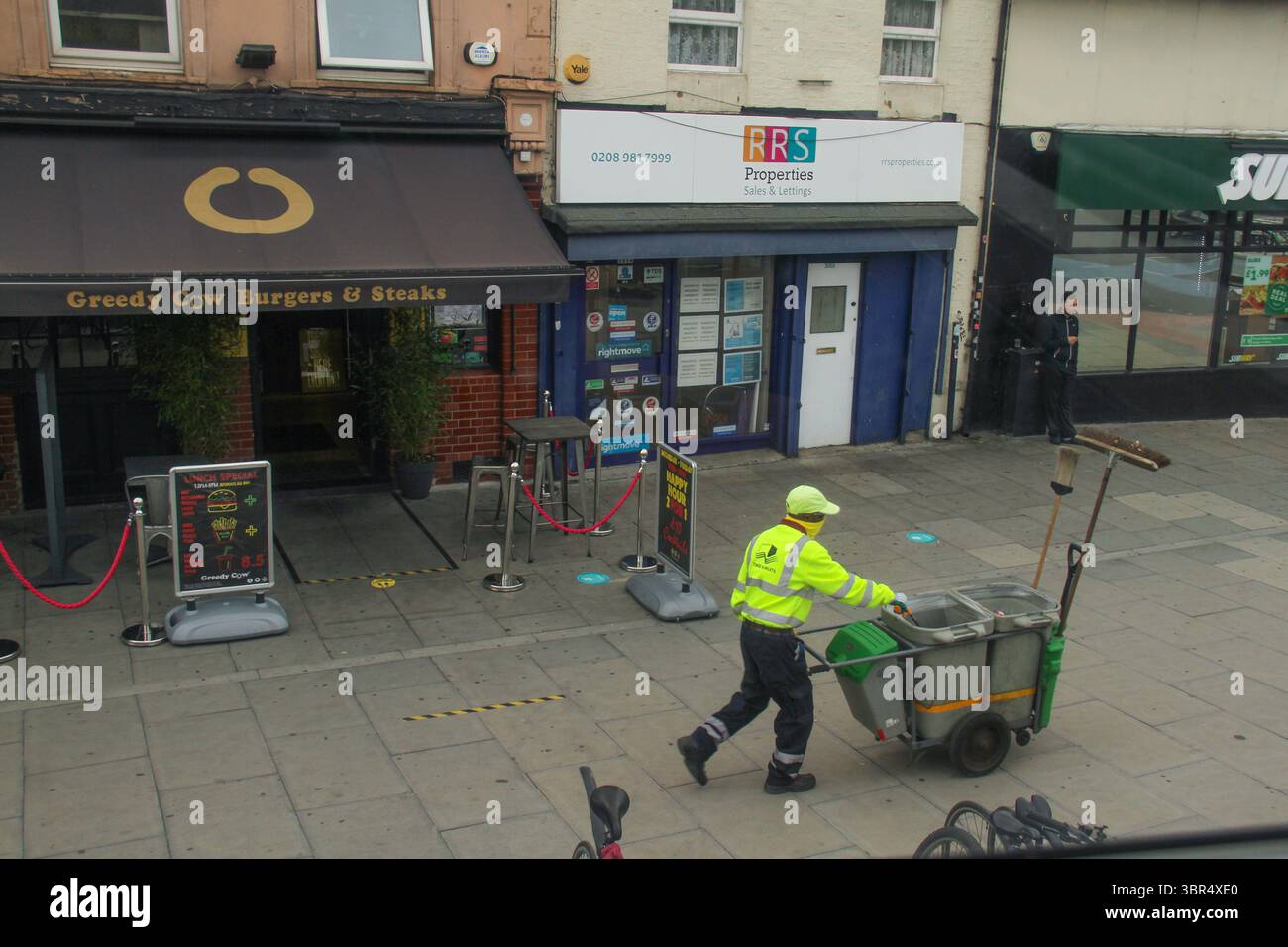 July 15, 2020, London, United Kingdom: A faced masked street cleaner at ...