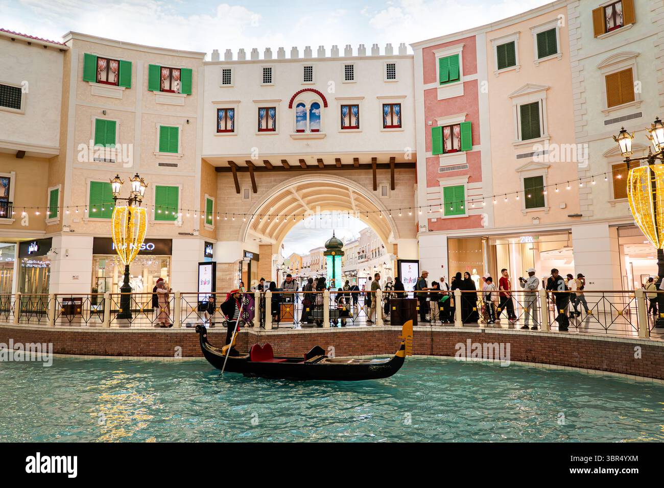 Doha, Qatar - February 2, 2025. Gondola in artificial canal, in ...