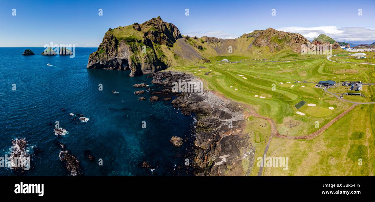 Aerial view of dramatic cliffs meet the verdant golf course, where the ...