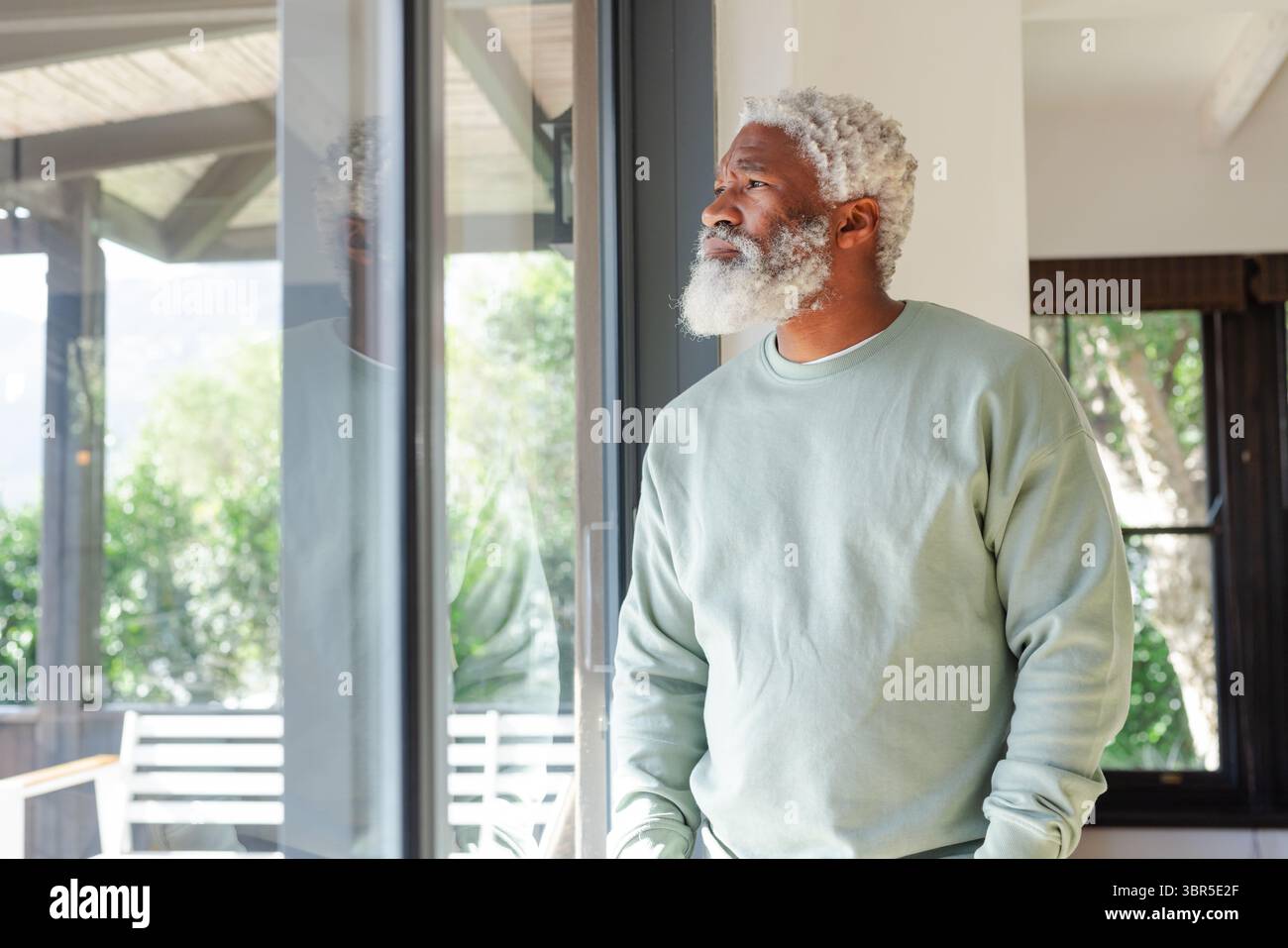 Man standing glass wall gazing hi-res stock photography and images - Alamy