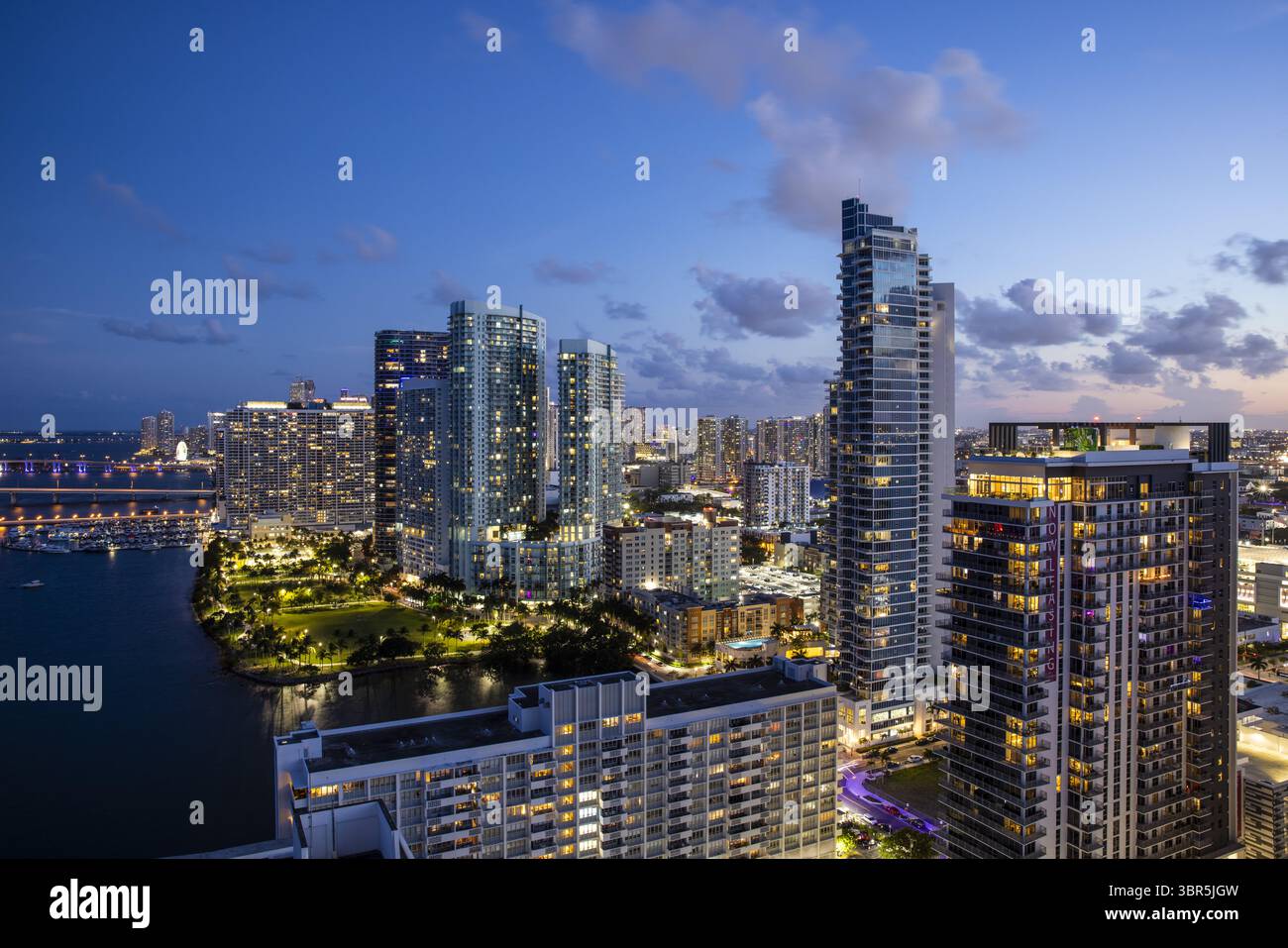 Aerial view of the gleaming cityscape and the MacArthur Causeway bridge ...