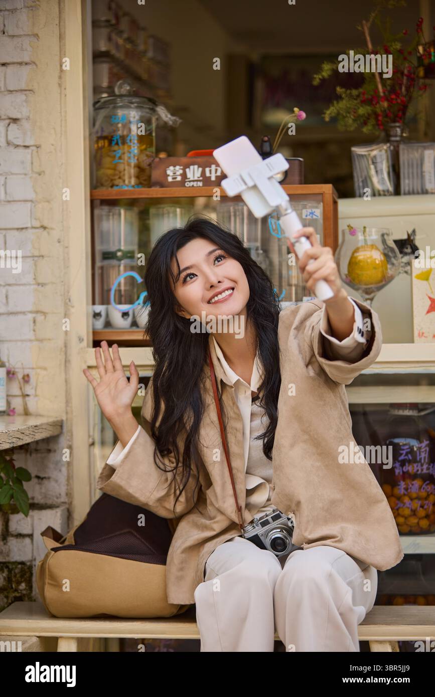 Young female influencer waving hi-res stock photography and images - Alamy