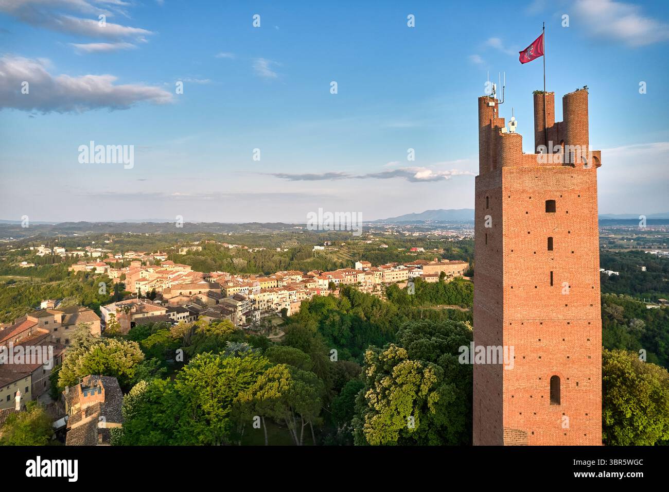 Aerial view of a medieval brick tower standing tall, topped with a ...