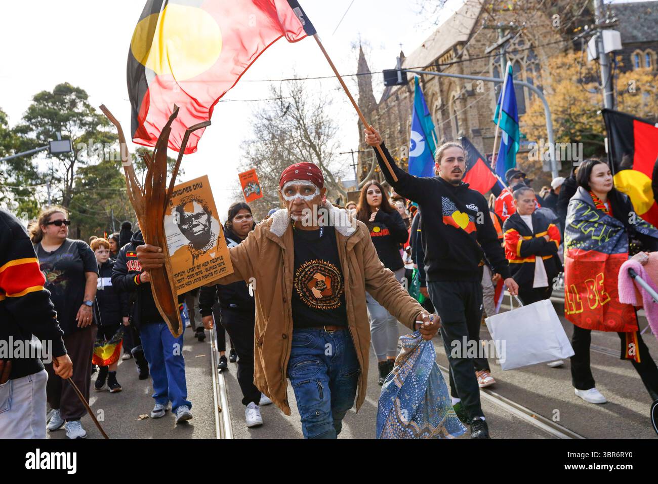 People holding flags participate in the annual Victorian NAIDOC march ...