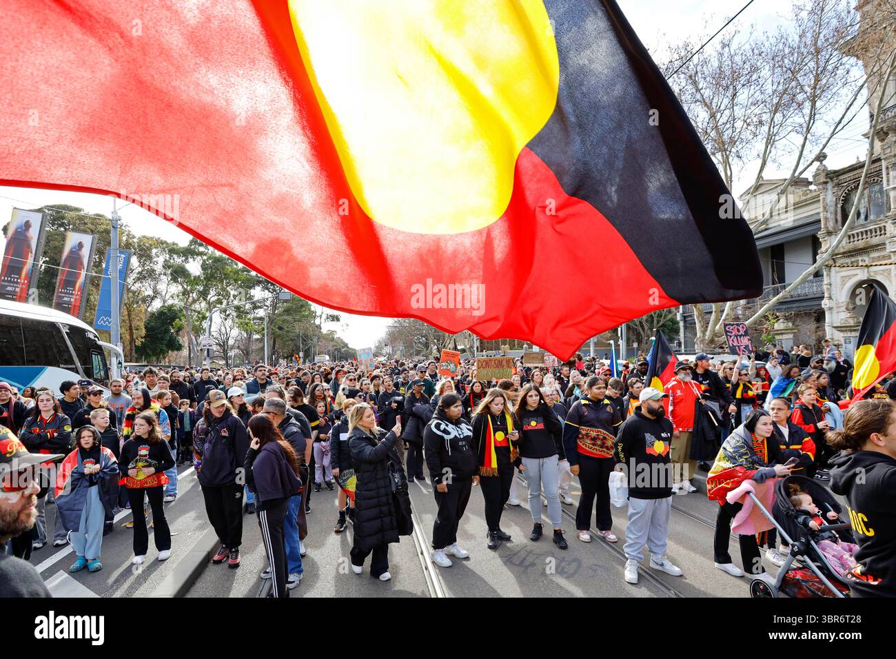 People holding flags participate in the annual Victorian NAIDOC march ...