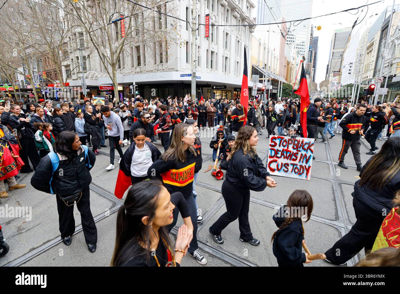 People holding flags participate in the annual Victorian NAIDOC march ...