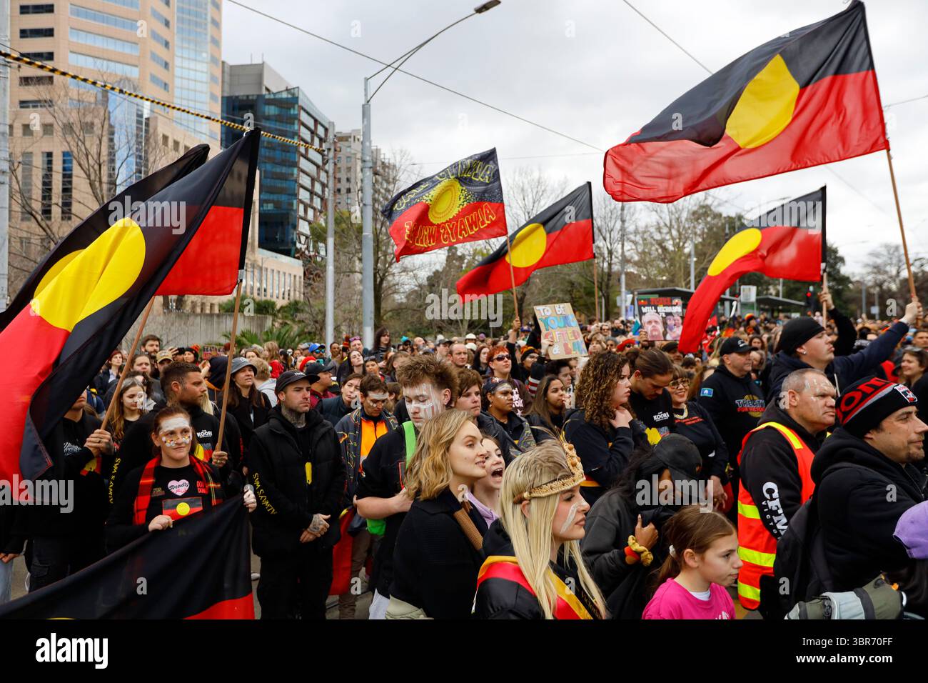 People holding flags participate in the annual Victorian NAIDOC march ...