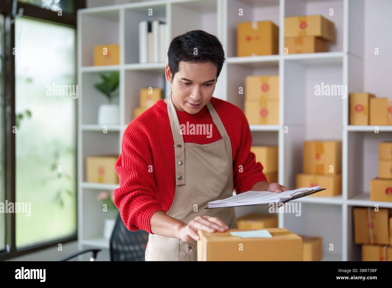 Small Business Owner Organizing Packages for Delivery Stock Photo - Alamy