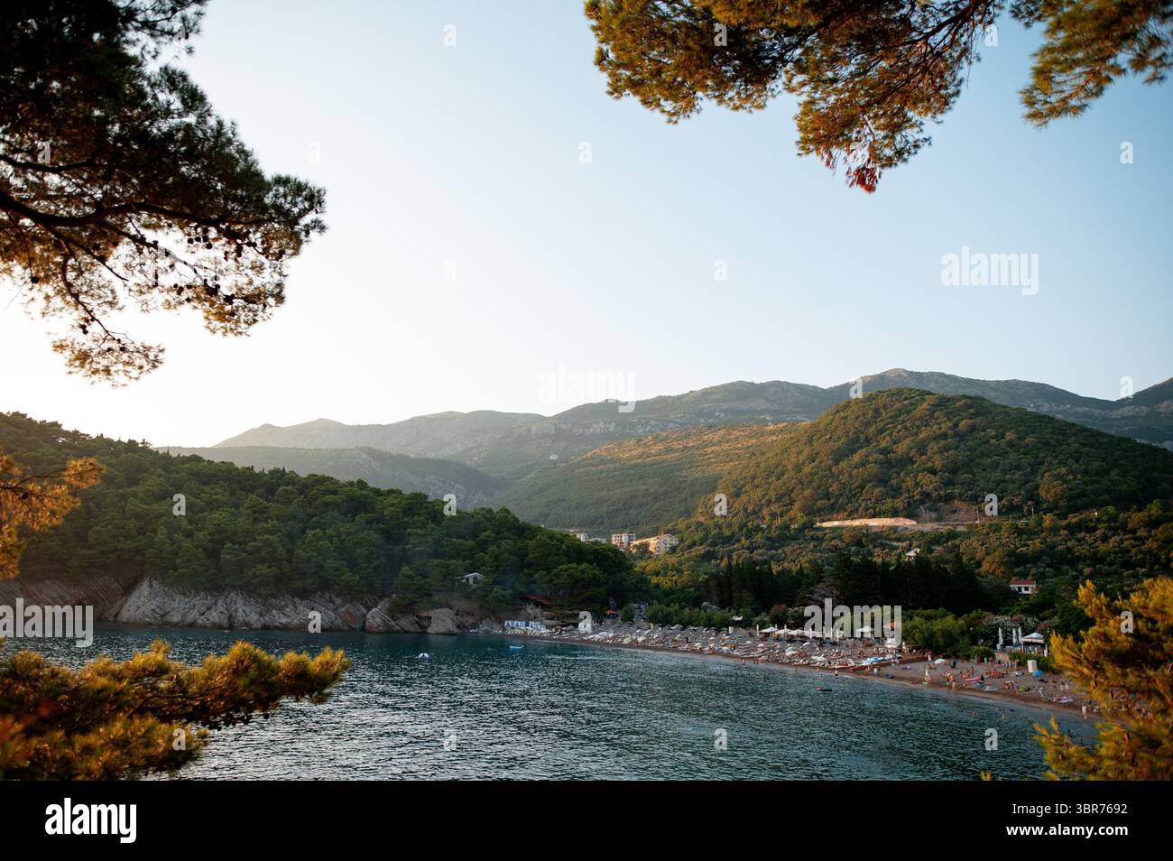 Serene Coastal Landscape with Sandy Beach and Lush Hills Stock Photo - Alamy