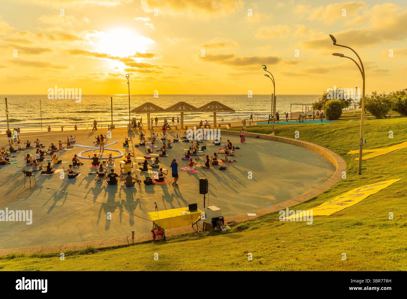 Haifa, Israel - July 09, 2025: People attend a Yoga session, calling ...
