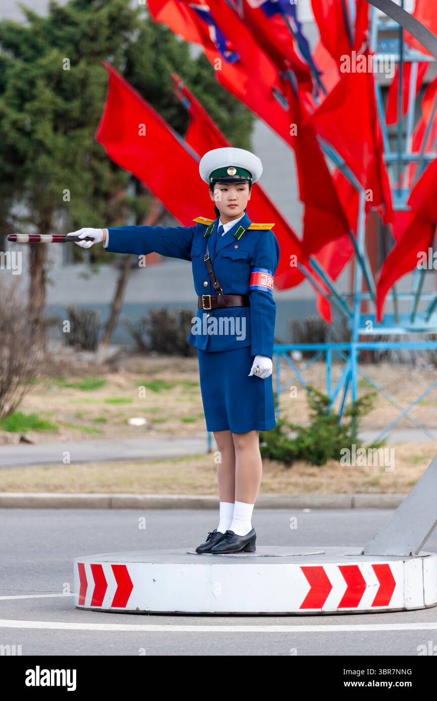 North Korean female traffic security officer in the street in front of ...