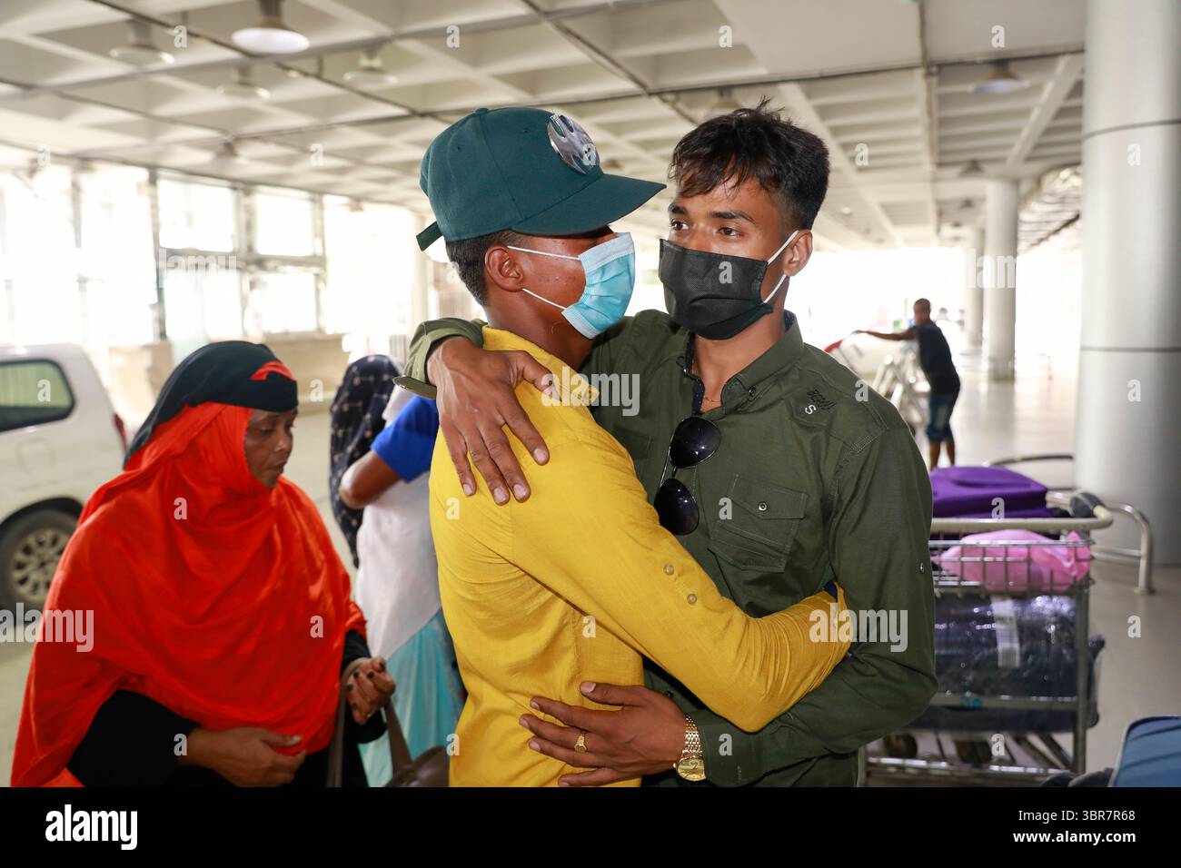 August 12, 2020, Dhaka, Bangladesh: Shahana Parveen gives hugs to her son Mafuj Hossian, who ...